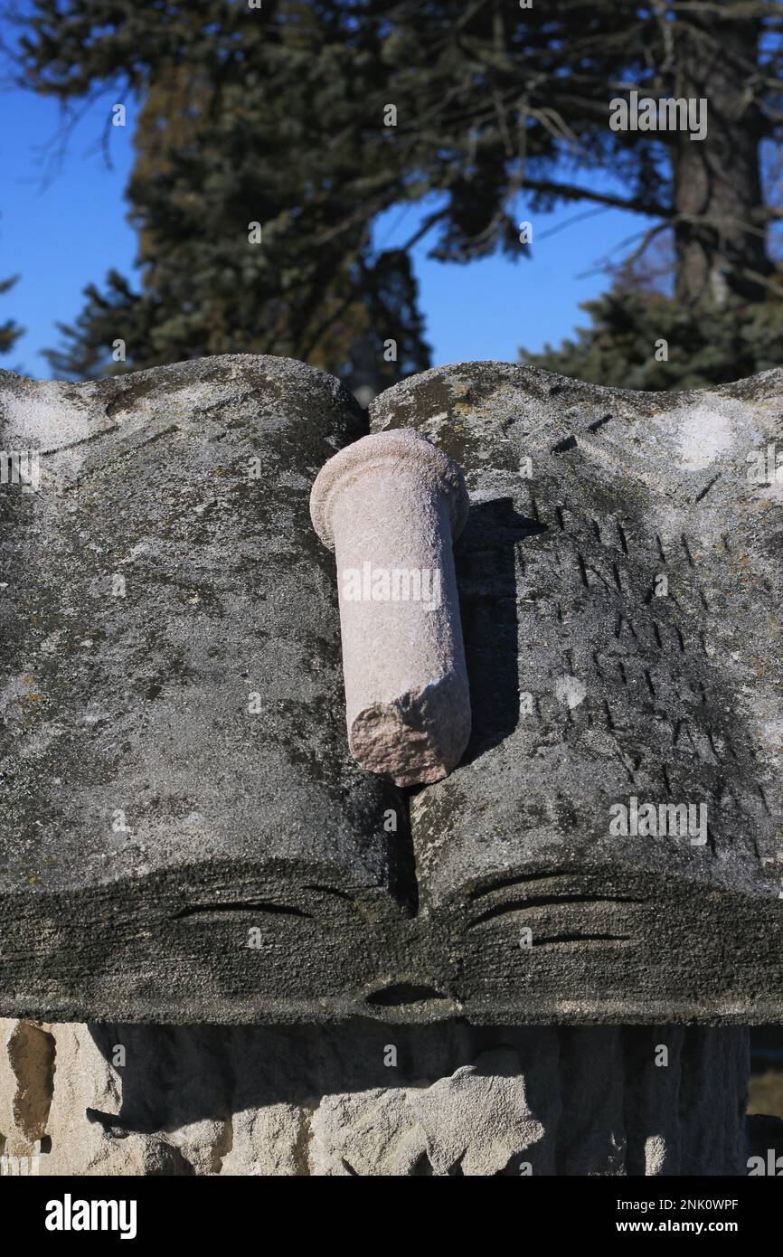 A vintage traditional open book carved out of natural stone Stock Photo ...