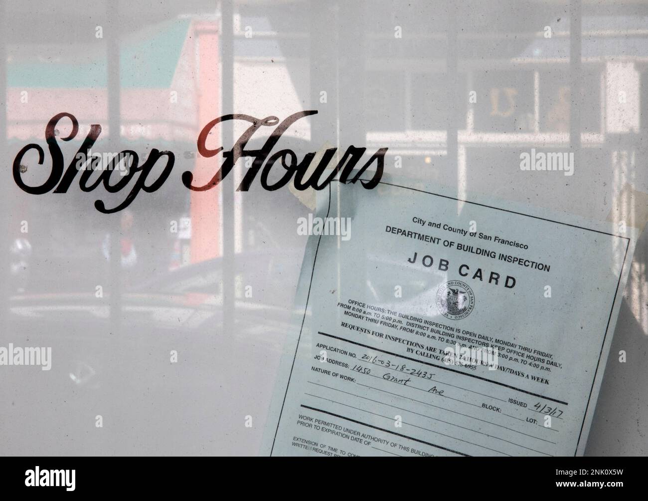 A notice of inspection hangs in the window of an empty storefront along ...