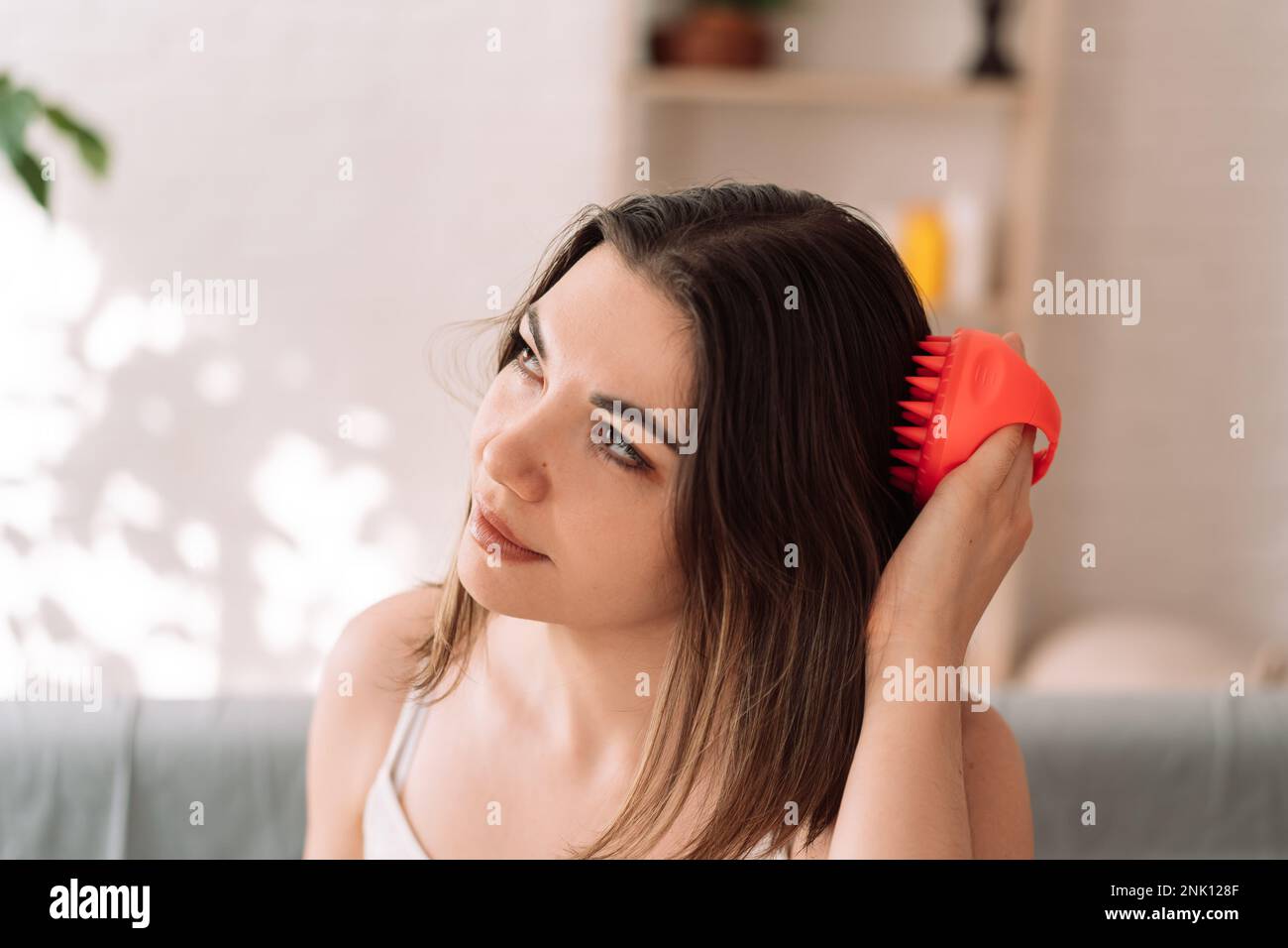 Woman Enjoys Doing Herself A Head Massage With A Scalp Massager Stock