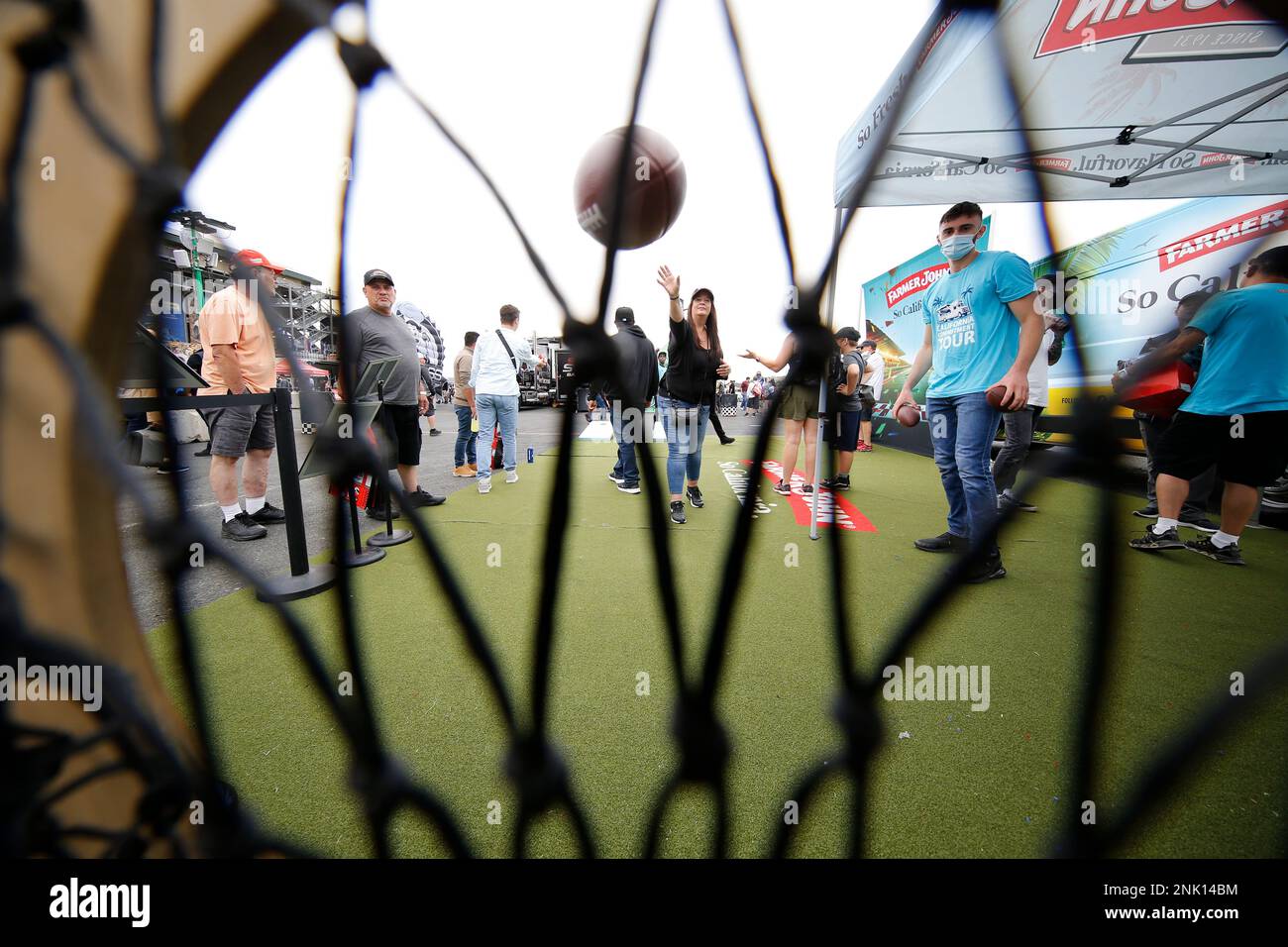 SONOMA, CA - JUNE 12: A fan tries the football toss in the Fan Zone ...
