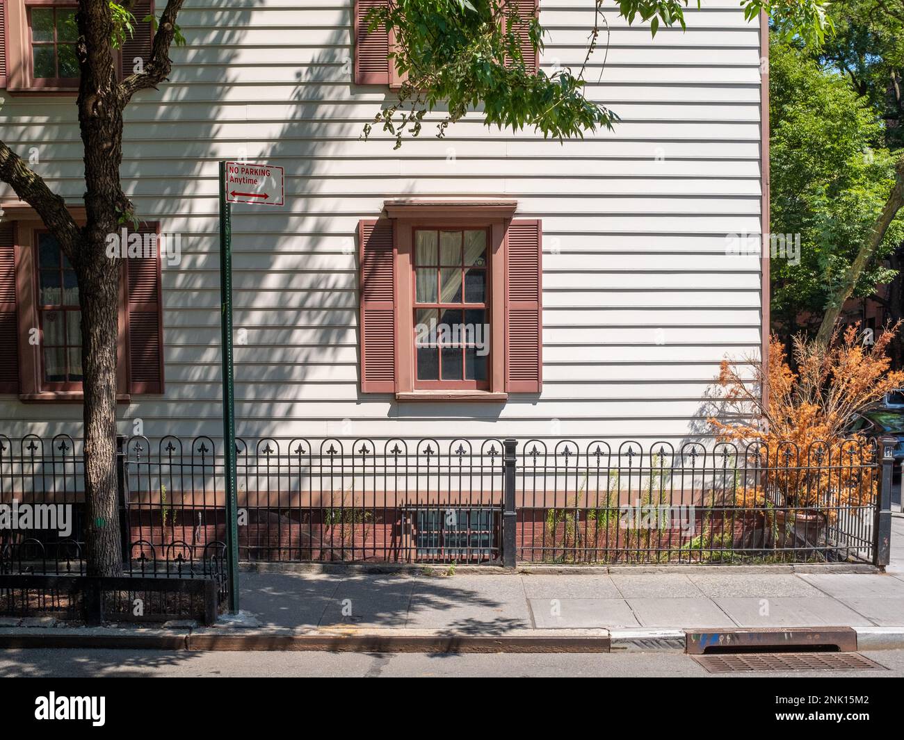 Brown windows and shutters on a building covered with clapboard in the ...