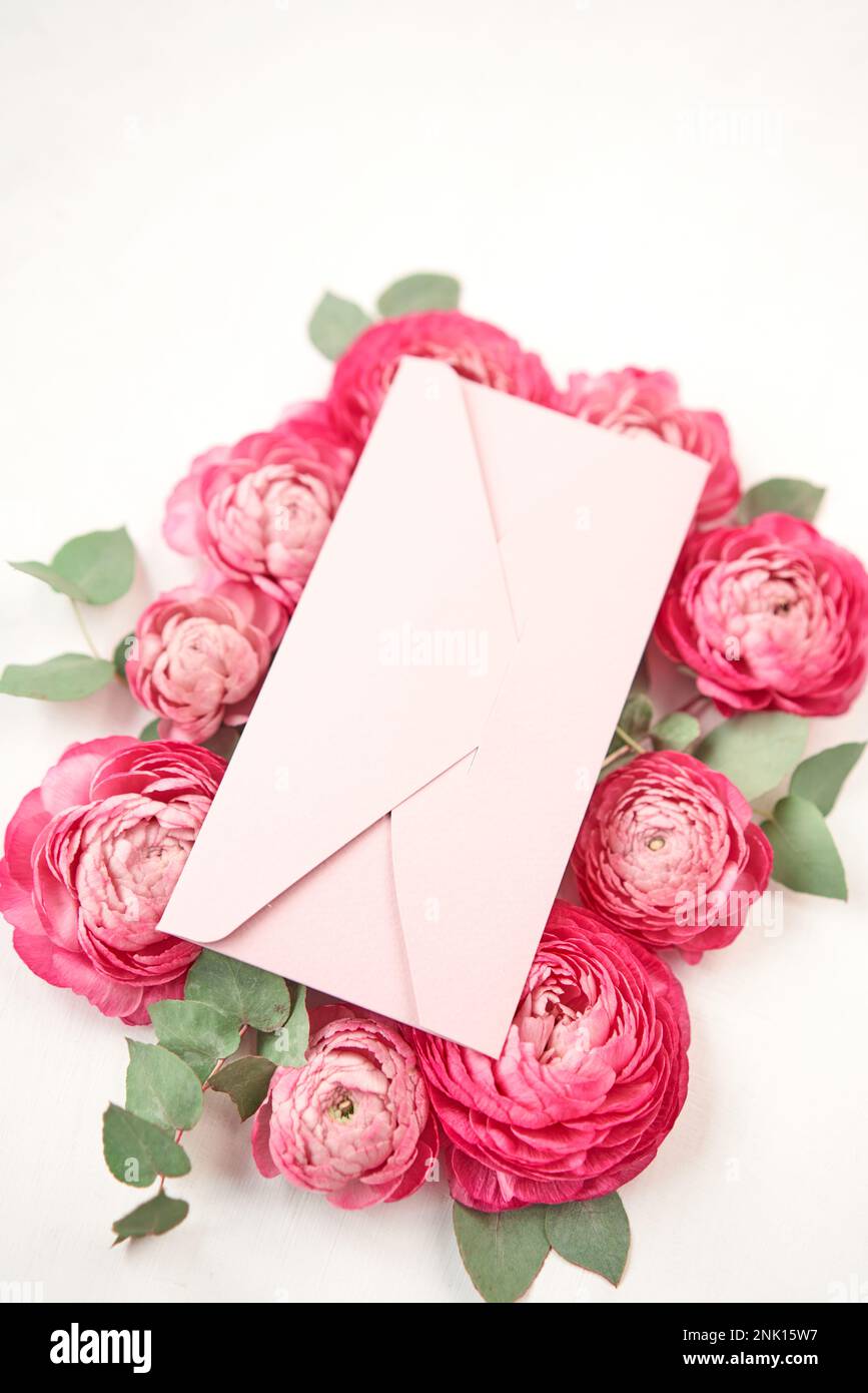 Love letter. Pink paper envelope mock up. Petals of flowers, roses and ...
