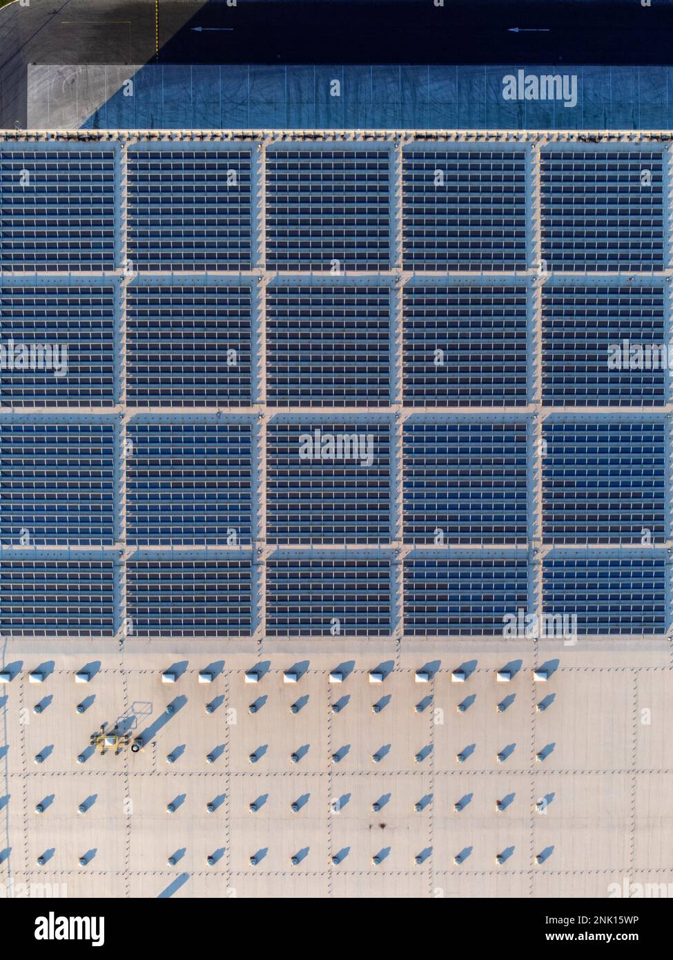 Large solar panel farm array on a commercial warehouse building, shot ...