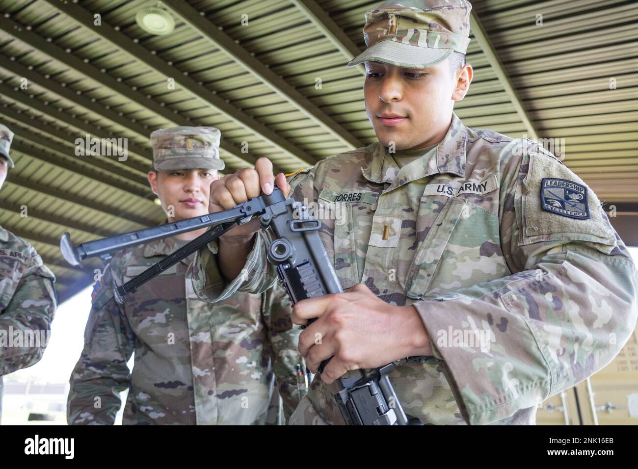 Second Lieutenant Kevin Luna-Torres assembles an M240B machine gun ...