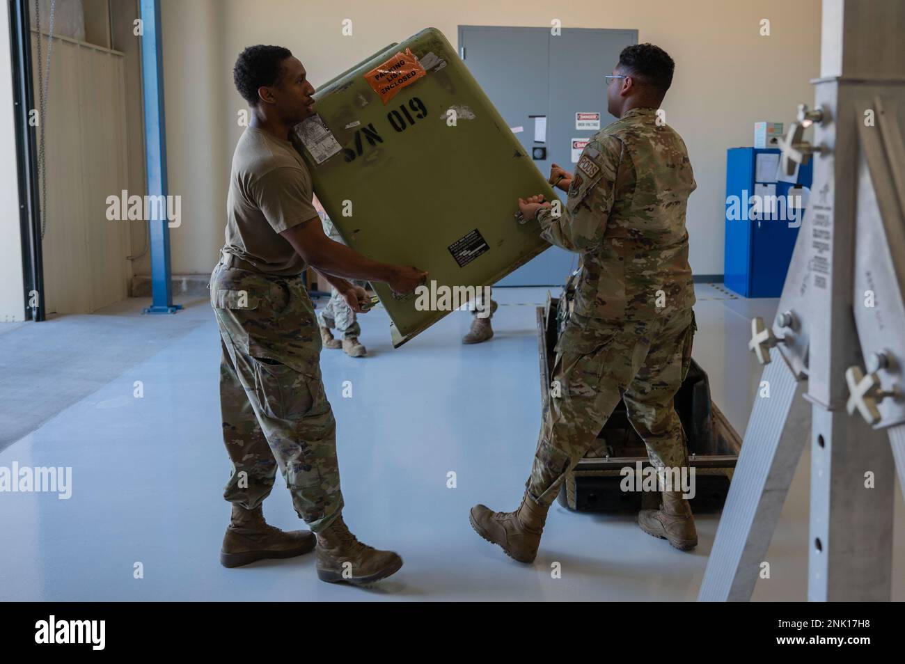 U.S. Airmen assigned to the 355th Component Maintenance Squadron remove the storage container ...