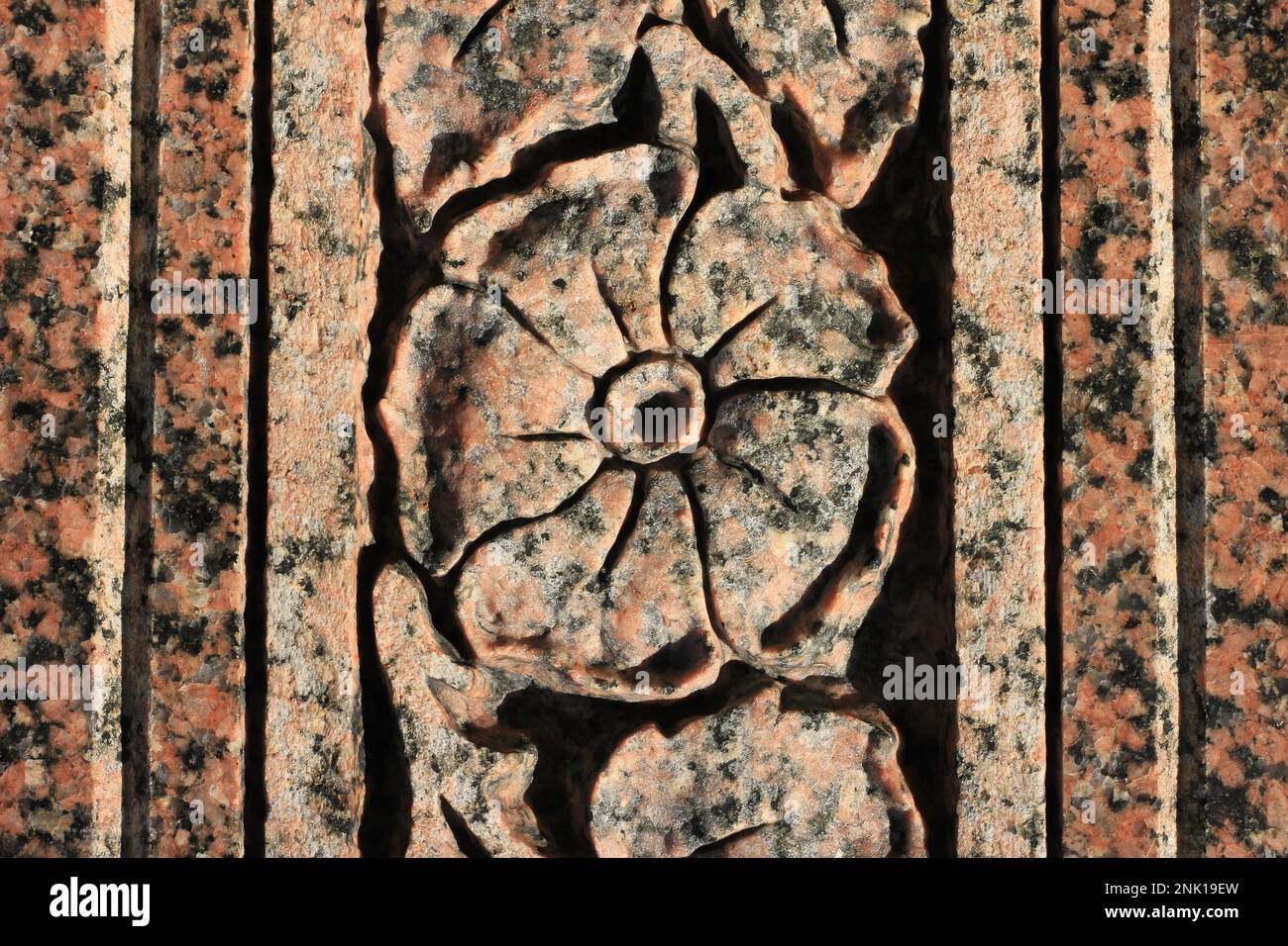 A natural stone flower carved in a slab of granite Stock Photo - Alamy