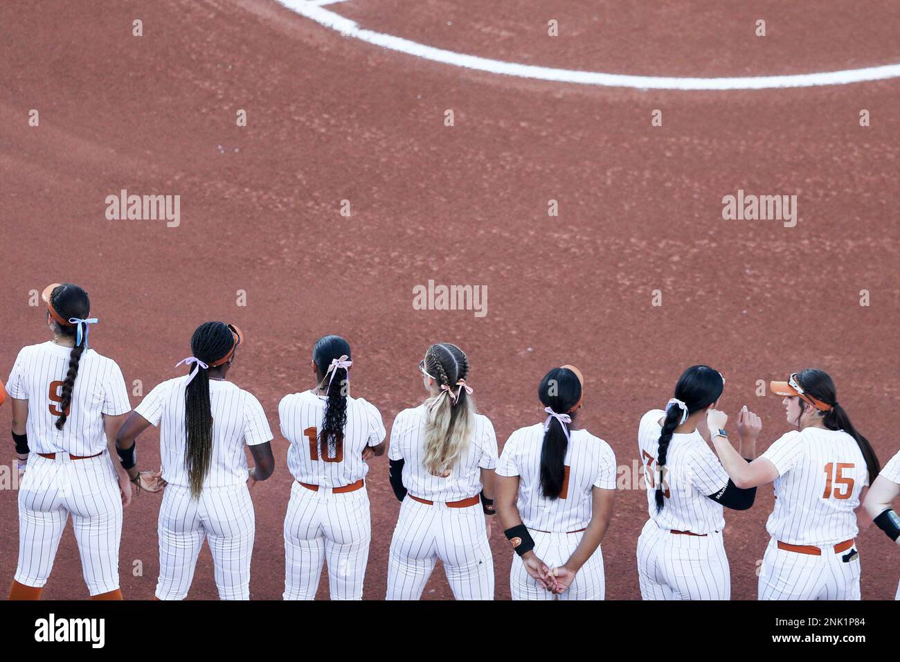 Texas pitcher Courtney Day (15) adjusts catcher Mary Iakopo's (33) hair ...