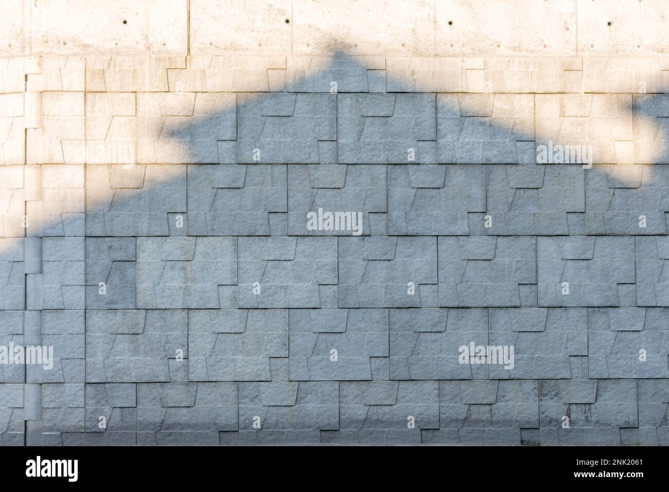 Abstract image of house shadow against concrete wall. Kanazawa, Japan ...
