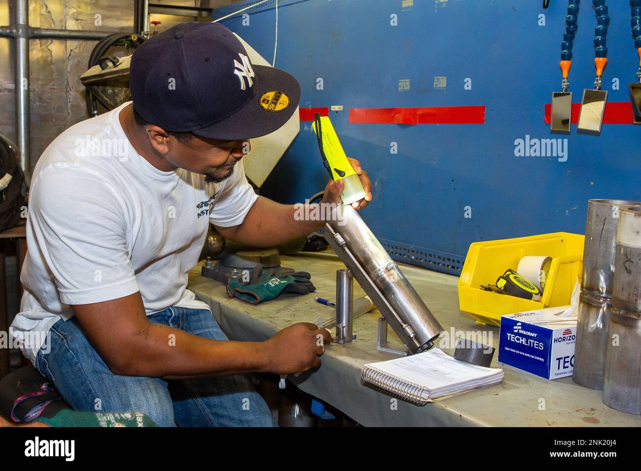 Welding Instructor Albert "A.J." Crayton inspects a pipe joint ...