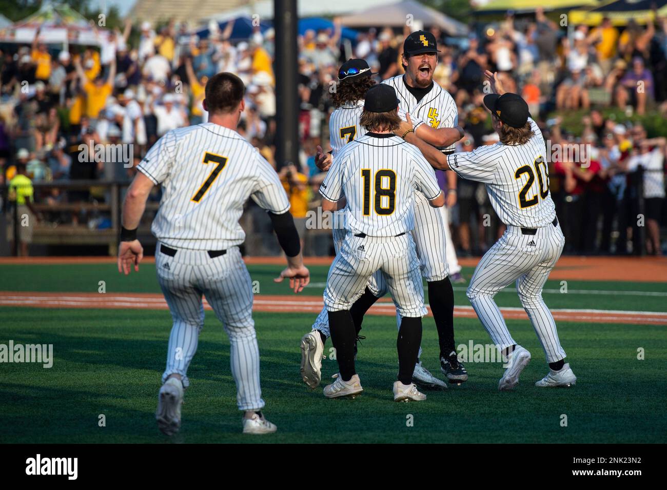 Southern Miss pitcher Tyler Stuart is embraced by his teammates as ...
