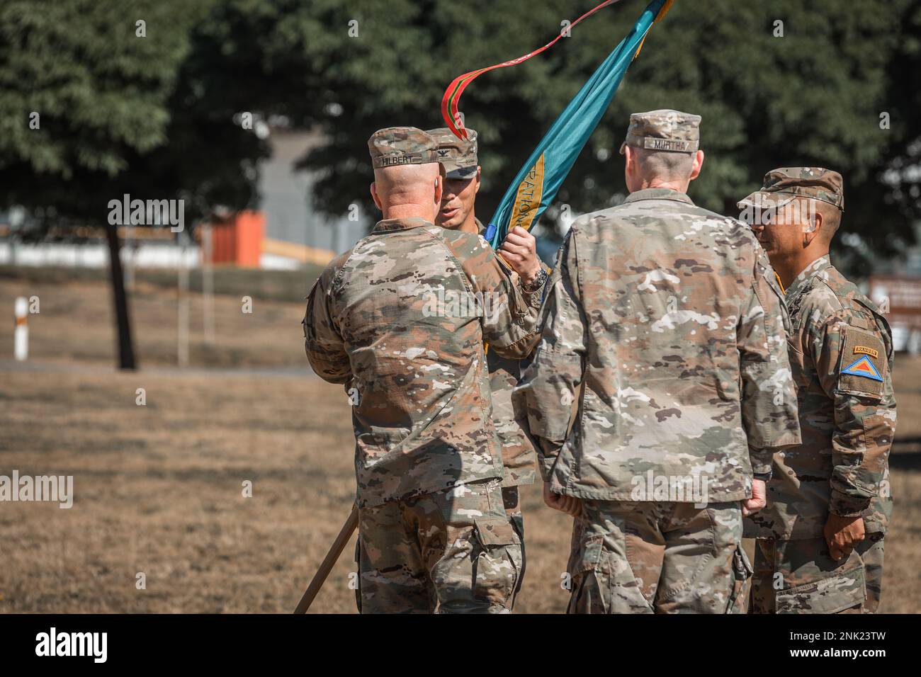 U.S. Army Brig. Gen. Joseph Hilbert (right) entrusts the unit guidon to ...