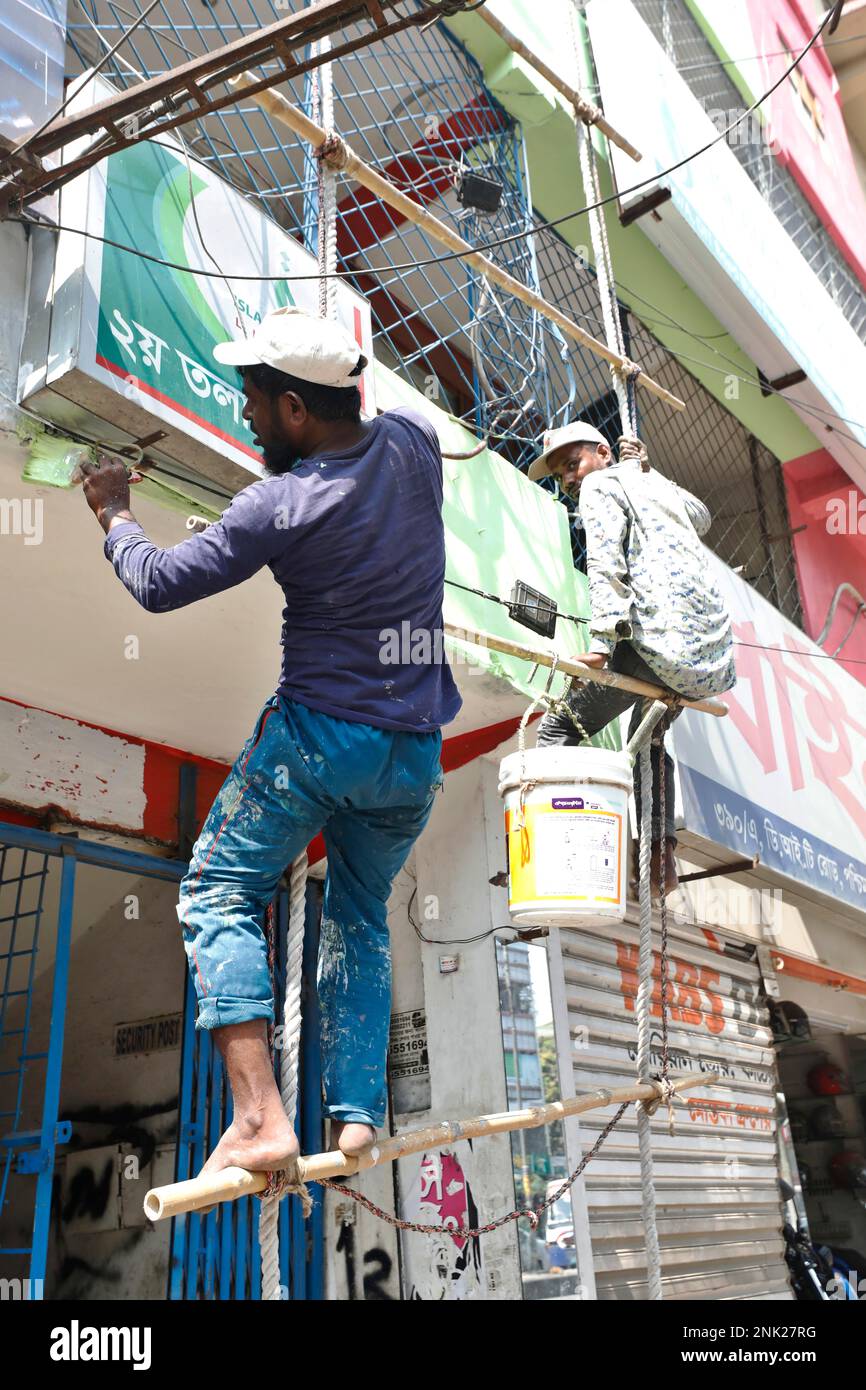 Dhaka, Bangladesh - February 23, 2023: Construction workers are hanging ...