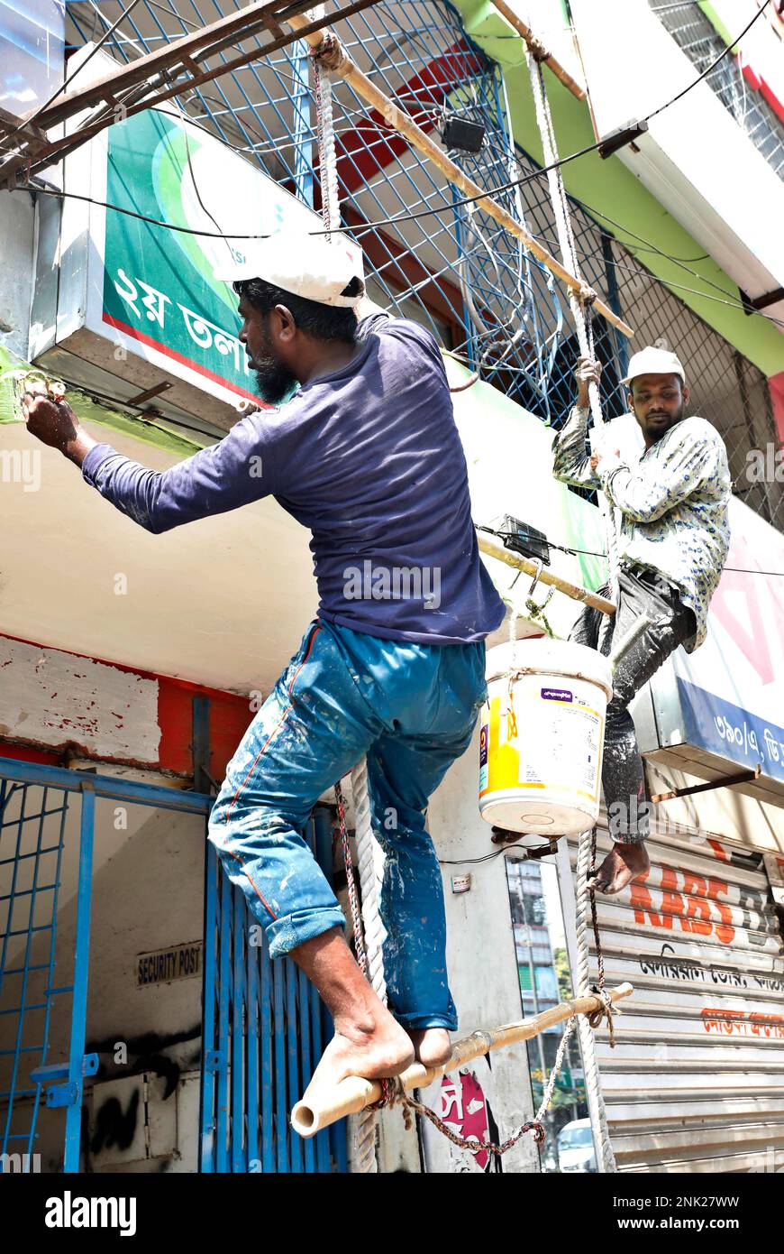 Dhaka, Bangladesh - February 23, 2023: Construction workers are hanging ...