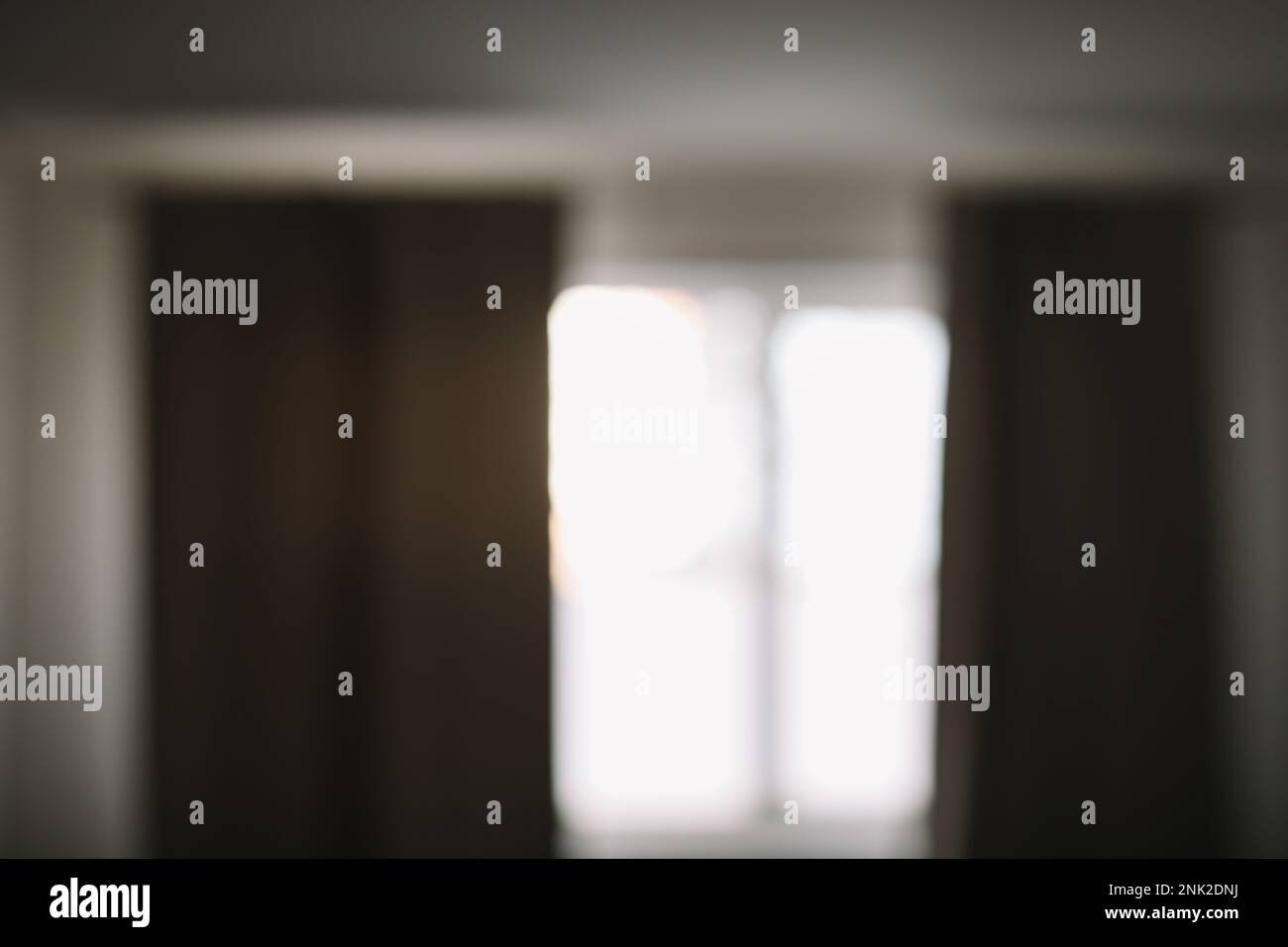 Blurred view of the living room with big window with curtains. window ...