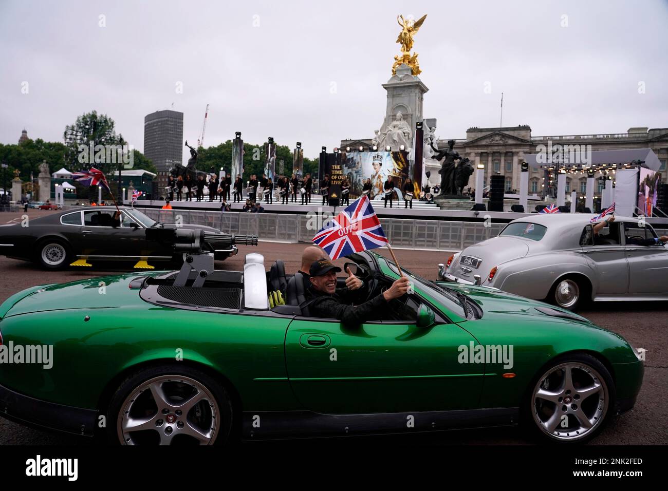 Drivers with cars parade during the Platinum Jubilee Pageant outside ...
