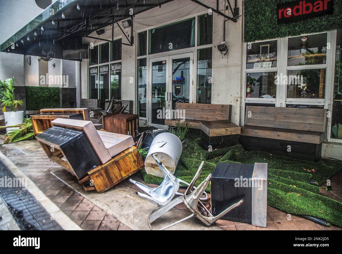 Furniture and plants from the RedBar Brickell bar litter the sidewalk ...