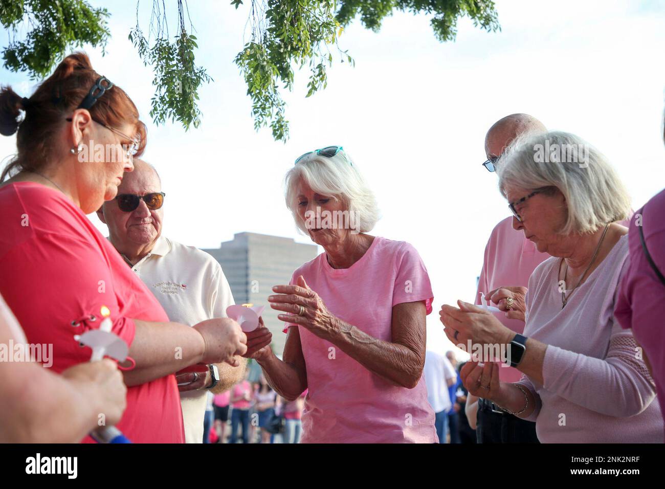 People light candles during a vigil for the victims of a shooting at ...