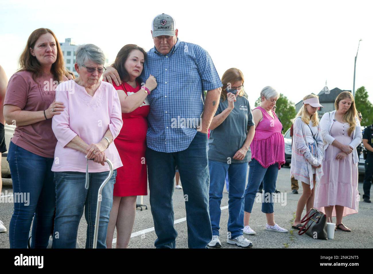 Cheryl Lowry, left, holds Deborah Love while Karen Love, third from ...