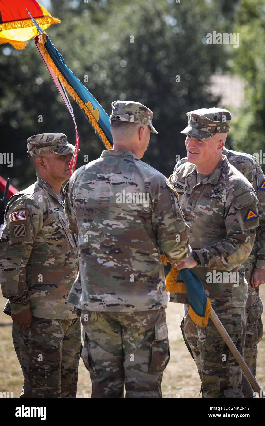 U.S. Army Brig. Gen. Joseph Hilbert (right) entrusts the unit guidon to ...