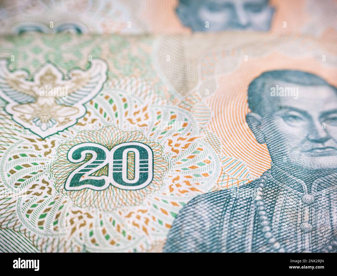 Macro detail with a 20 Thai Baht banknote. the baht is the official ...