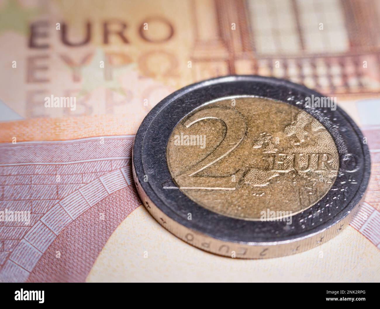 Macro picture of a 2 euro coin on a 50 Euro Banknote. European Currency ...