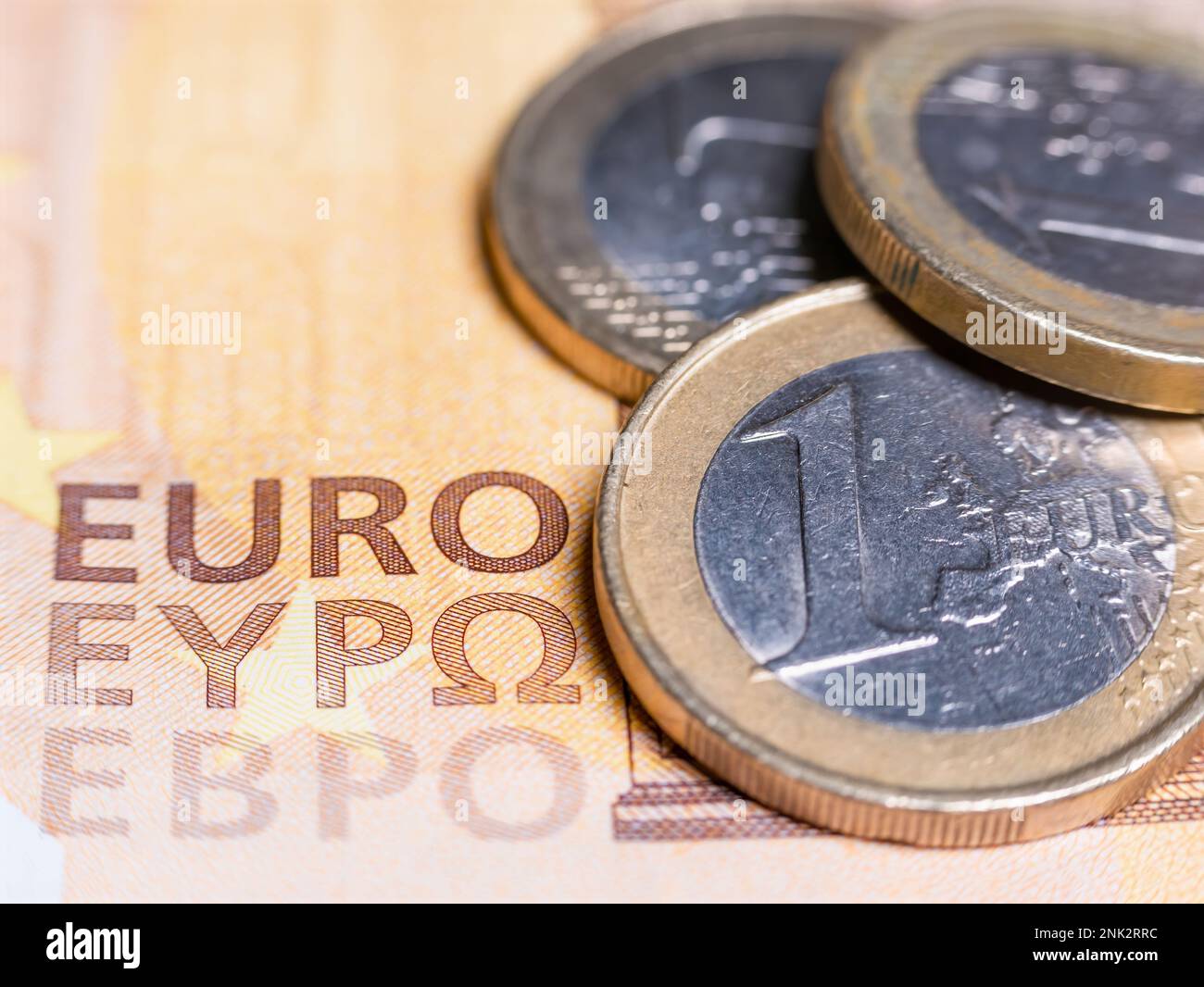Macro picture of a 1 euro coin on a 50 Euro Banknote. European Currency ...