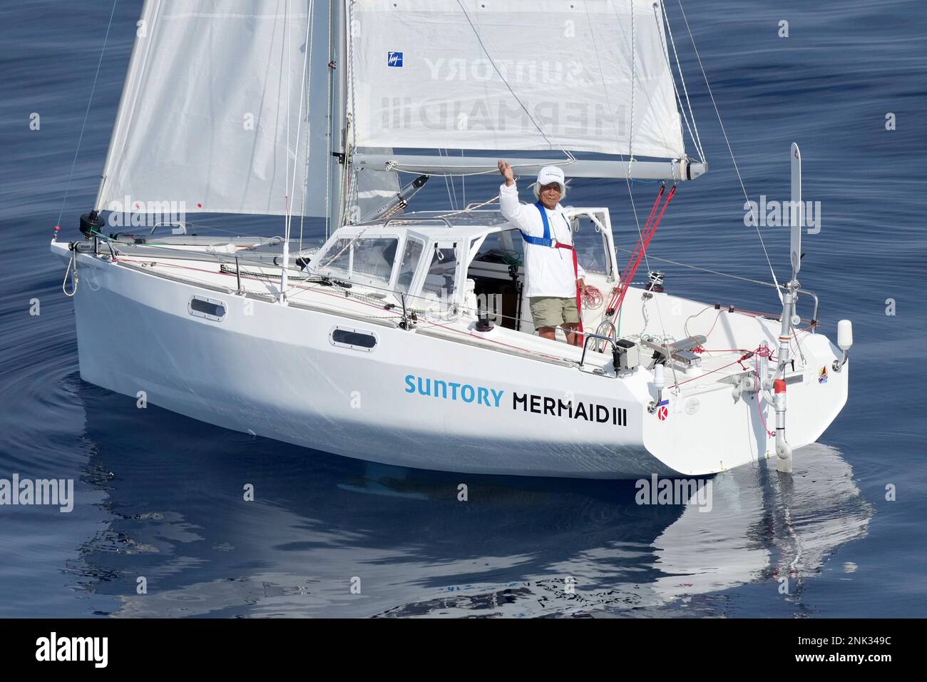 An aerial photo shows Kenichi Horie swinging his hands from a yacht off ...