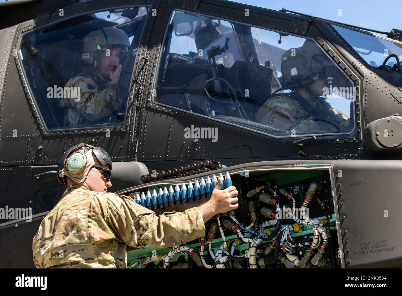 U.S. Army Cpl. Nathaniel Miller (bottom left), an AH-64 Armament ...