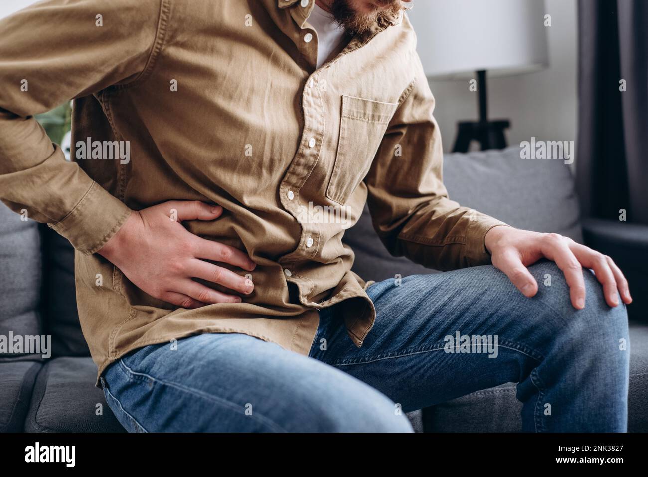 Man squeezing belly hi-res stock photography and images - Alamy