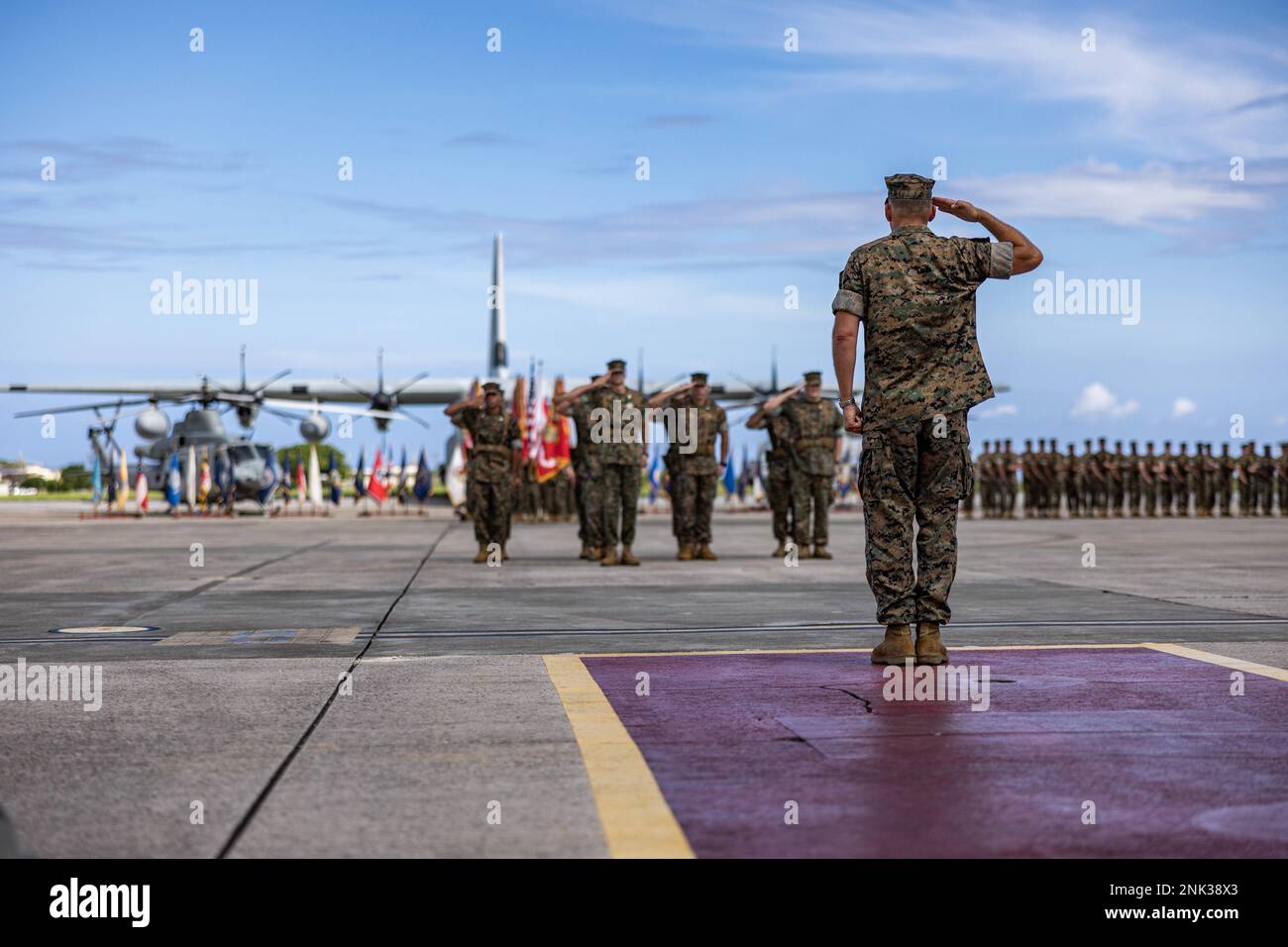 U.S. Marine Corps Major General Eric E. Austin salutes a formation ...