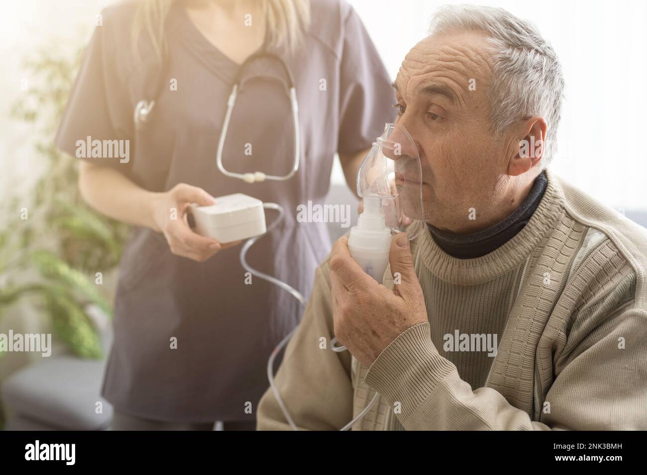 Elderly Senior Man nursing care wear oxygen inhaler device for helping ...