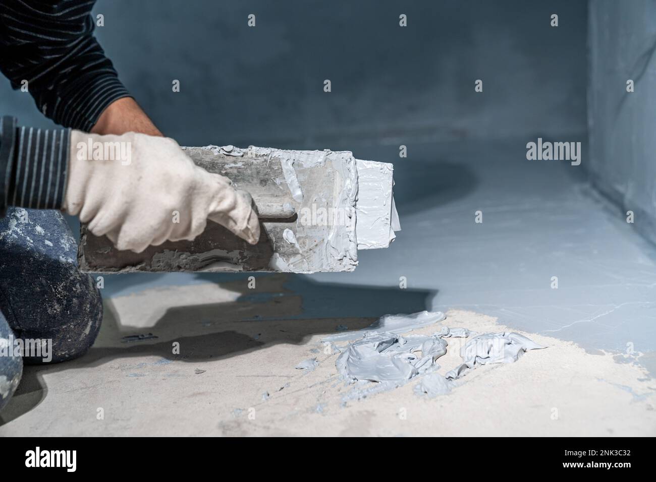 construction modifications of the floor and walls with trowel of a room ...