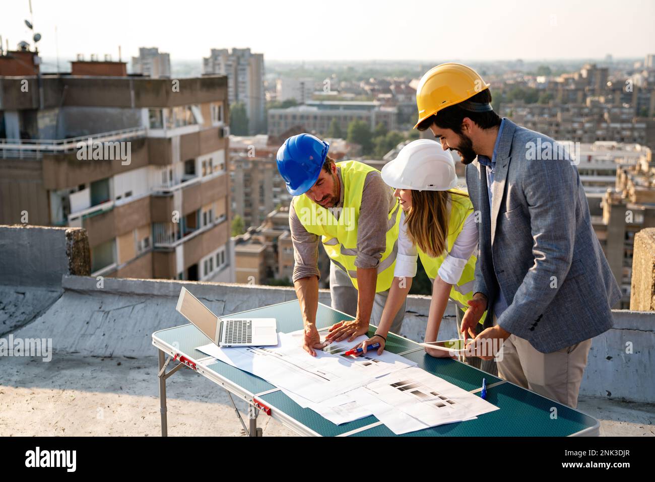 Group of engineers, architects, business partners at construction site ...