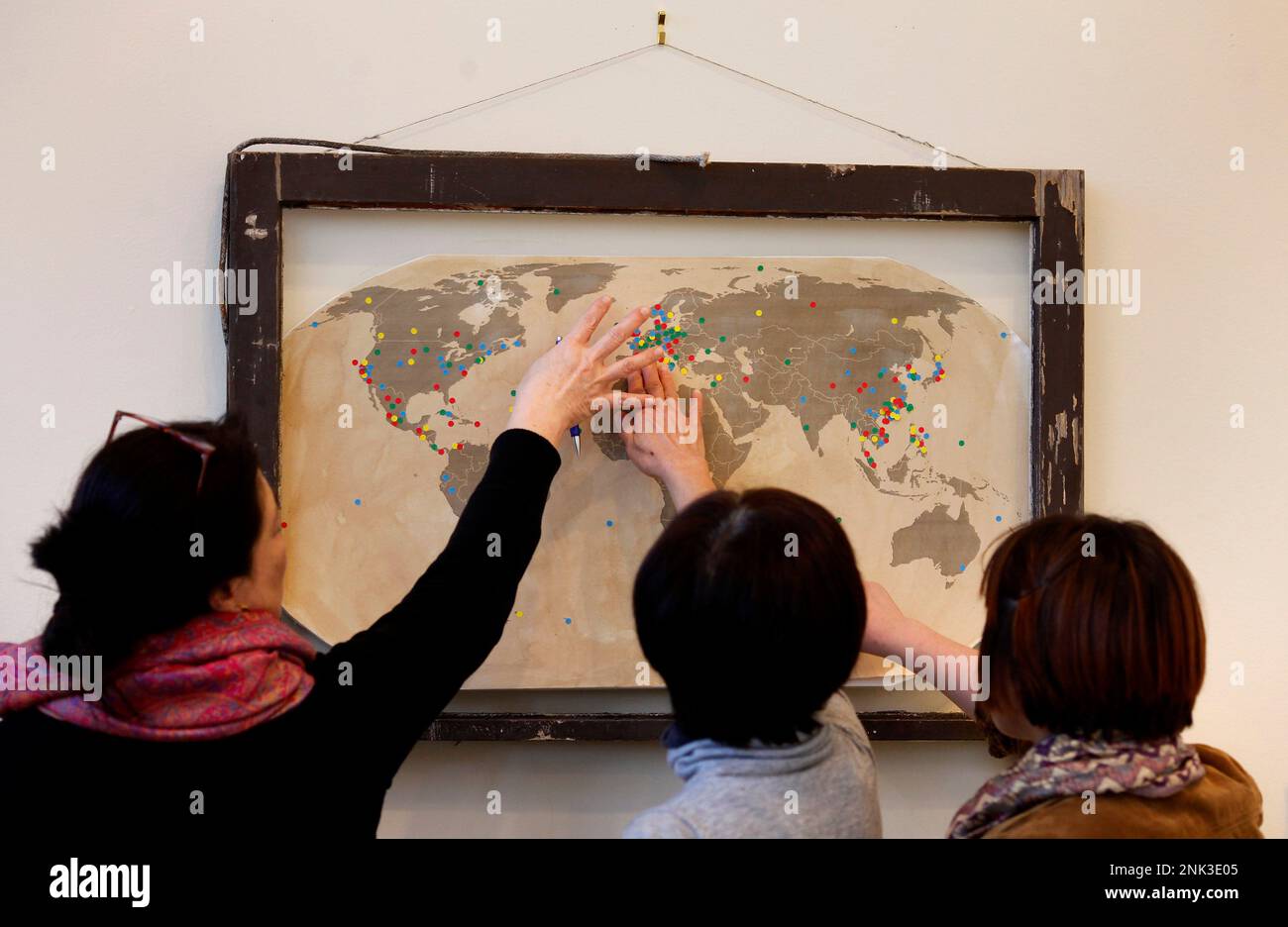 A world map has dots placed on it where people have placed their ...