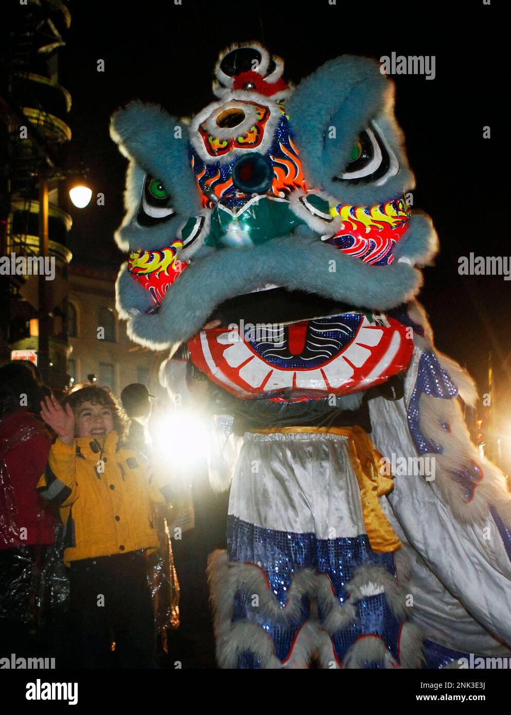 A child waves to one of the SFPD Lion Dance Team members at the annual ...