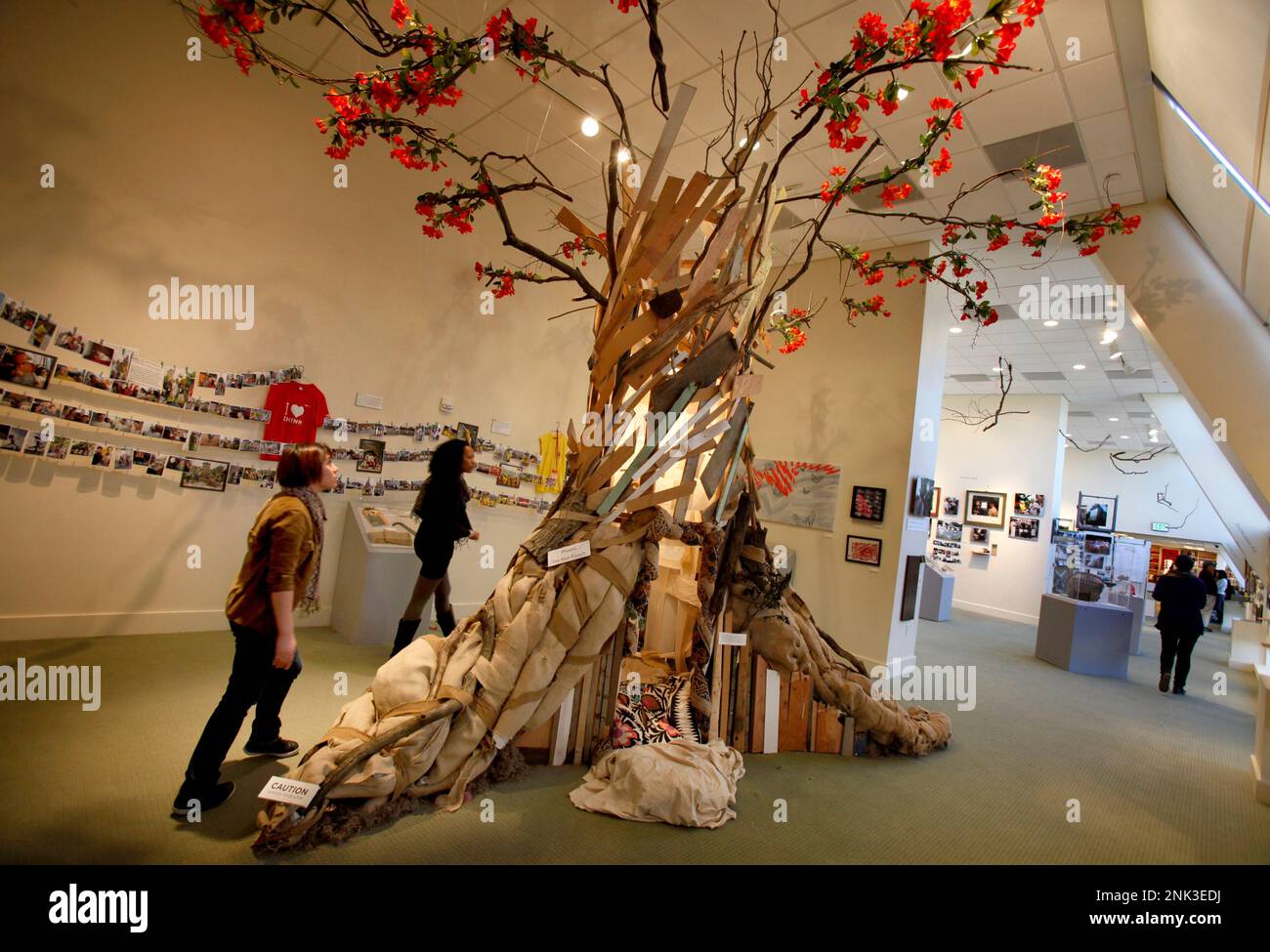 A large tree made of recycled materials symbolizes the roots system of ...