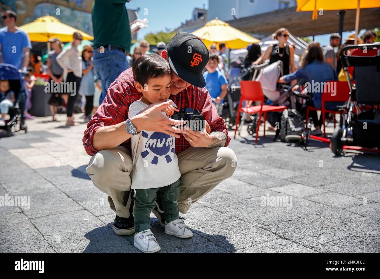 Brandon Cunningham assists his son Remi Cunningham, 1, in taking a ...