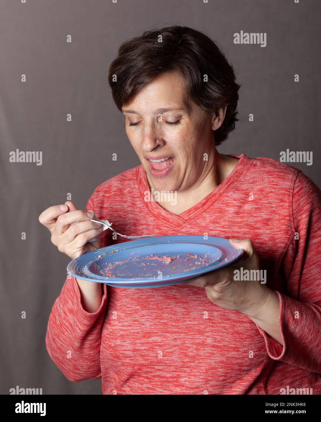 One woman eating empty plate hi-res stock photography and images - Alamy