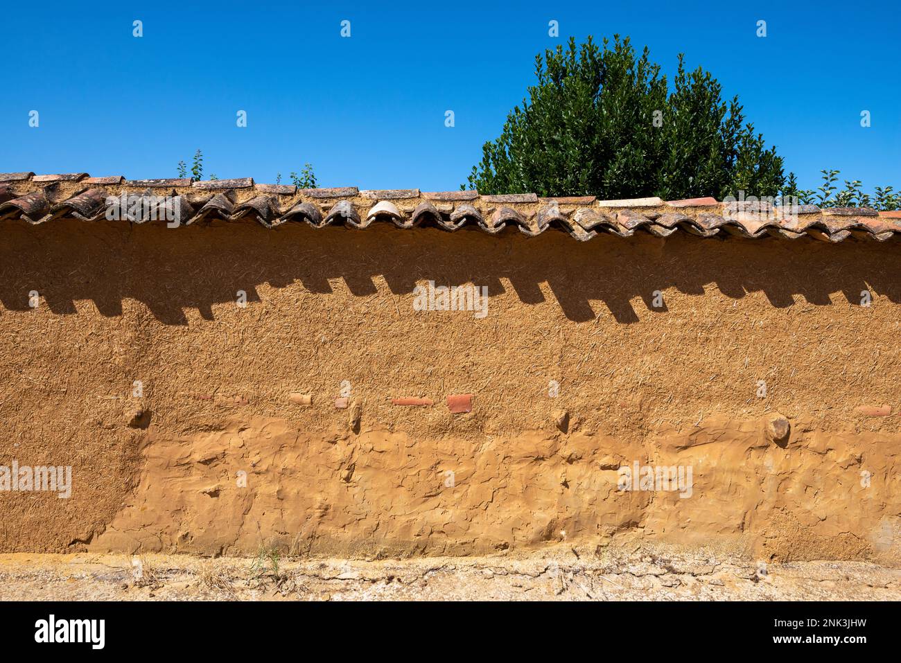 A traditional adobe wall along the Camino de Santiago pilgrimage route ...