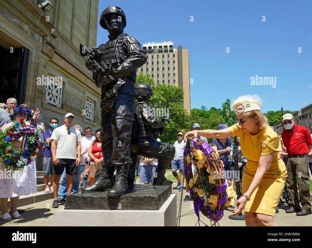 Gold Star Wife Lorri Spada, of Peters, places a wreath at the base of a ...