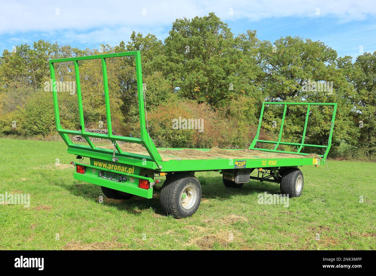 Trailer for transporting hay bales in a meadow Stock Photo - Alamy