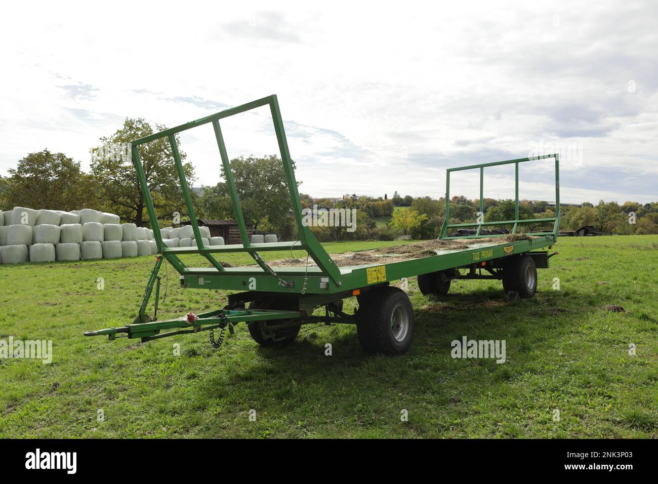Trailer for transporting hay bales in a meadow Stock Photo - Alamy