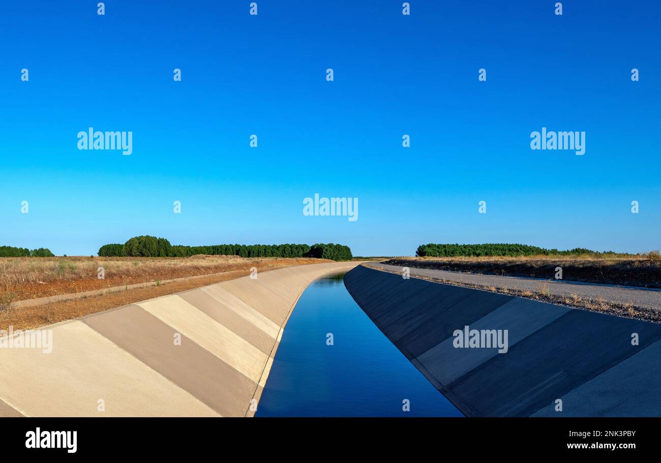 An irrigation canal snakes its way through the Spanish countryside ...