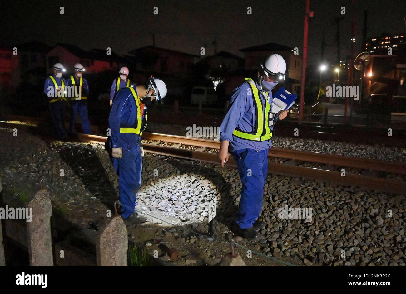 A photo shows a railroad crossing of the Odakyu Electric Railway ...