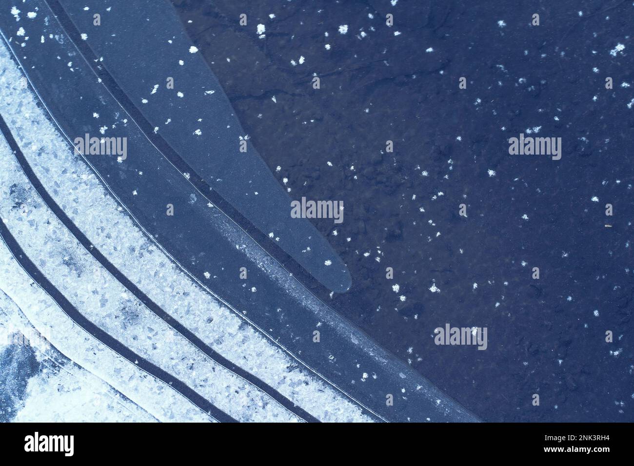 Abstract black and white toned image features a top-down view of a ...