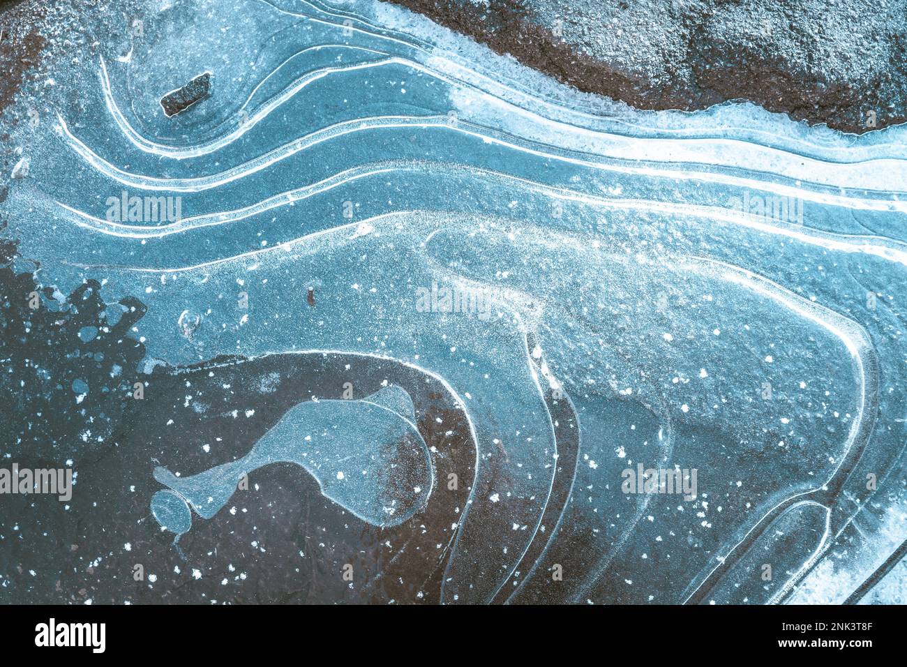 Blue ice formation with white curvy snow stripes and bulb-shaped ice ...