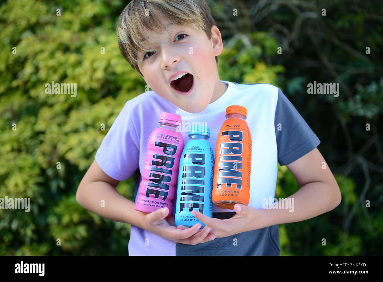 Happy boy with Prime drinks Stock Photo - Alamy