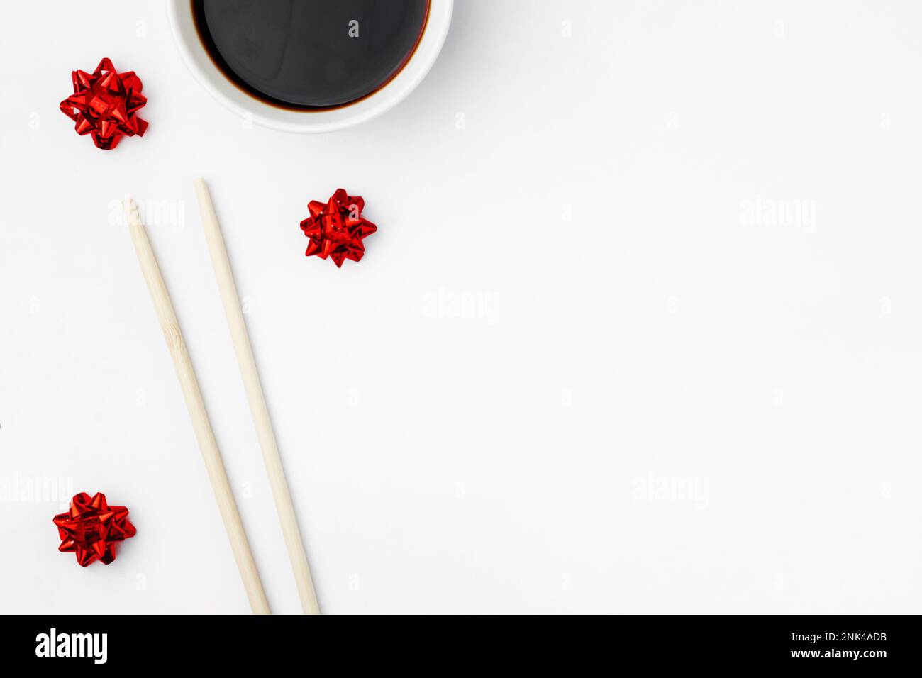 Bamboo sushi sticks are isolated on a white background, next to soy ...