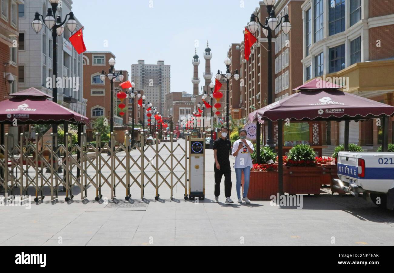 A street is decorated with lanterns and Chinese national flags during ...