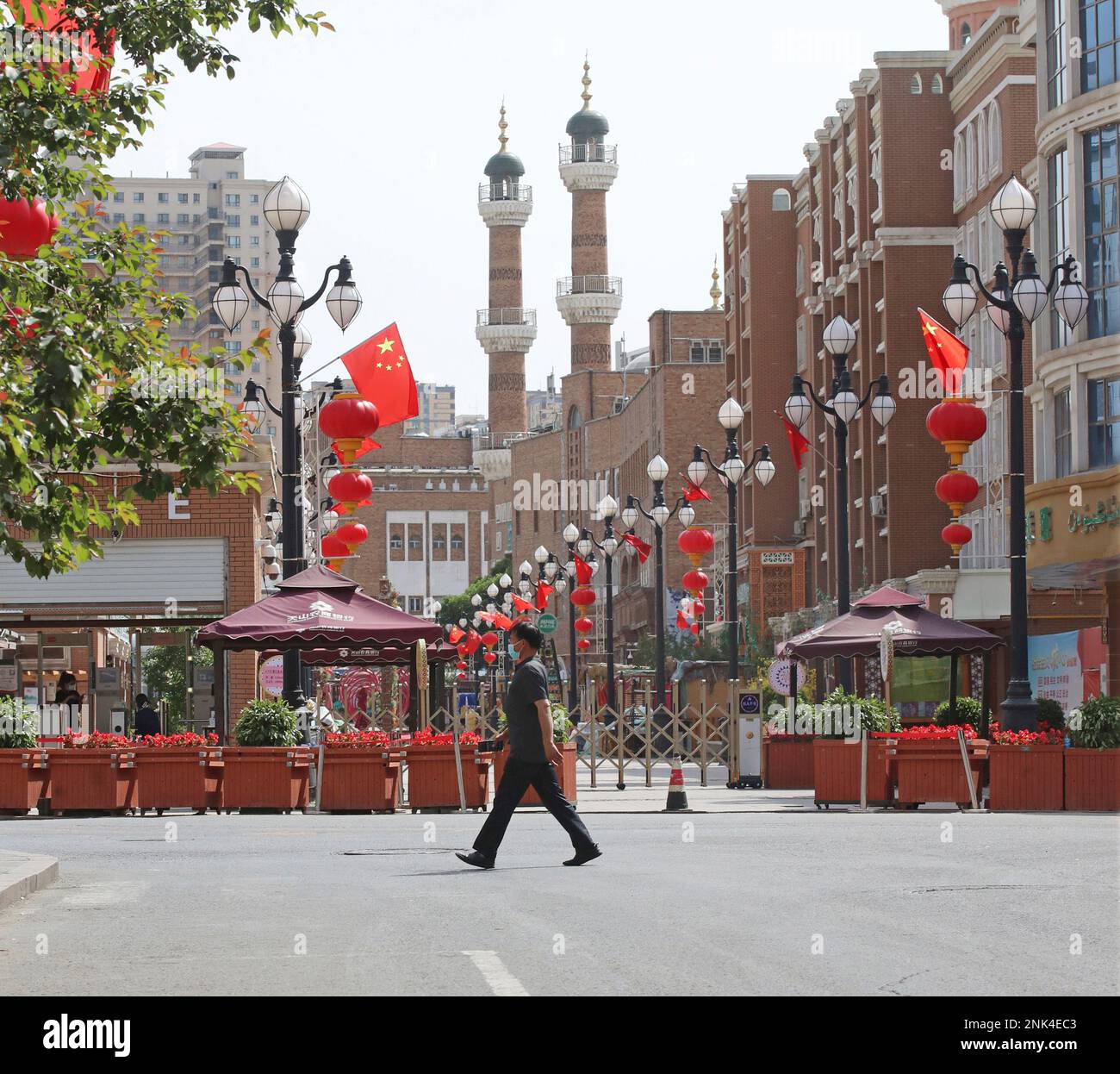 A street is decorated with lanterns and Chinese national flags during ...